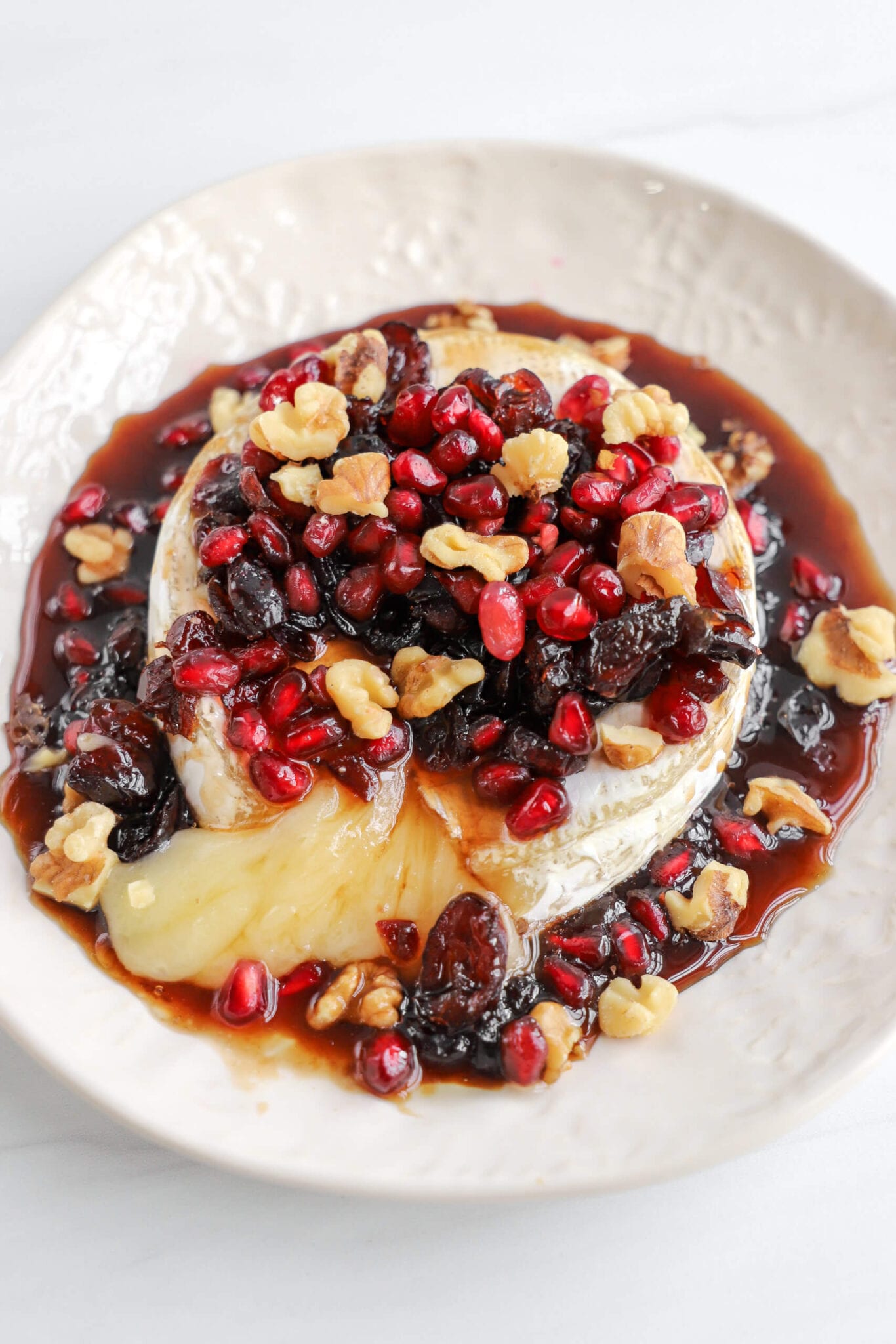 Sweet Baked Brie with Pomegranates, Cranberries, and Walnuts
